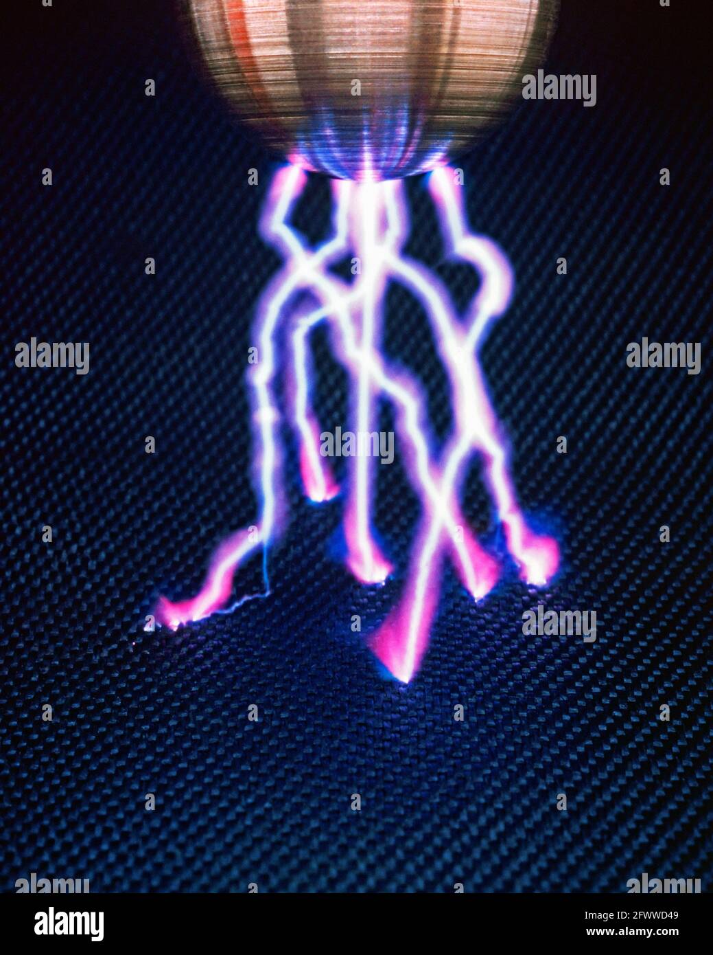 An electric charge of 45;000 volts snakes over composite material ...