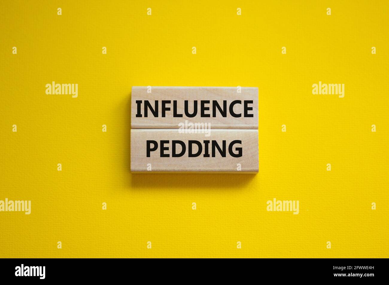 Influence pedding symbol. Wooden blocks with words 'Influence pedding ...
