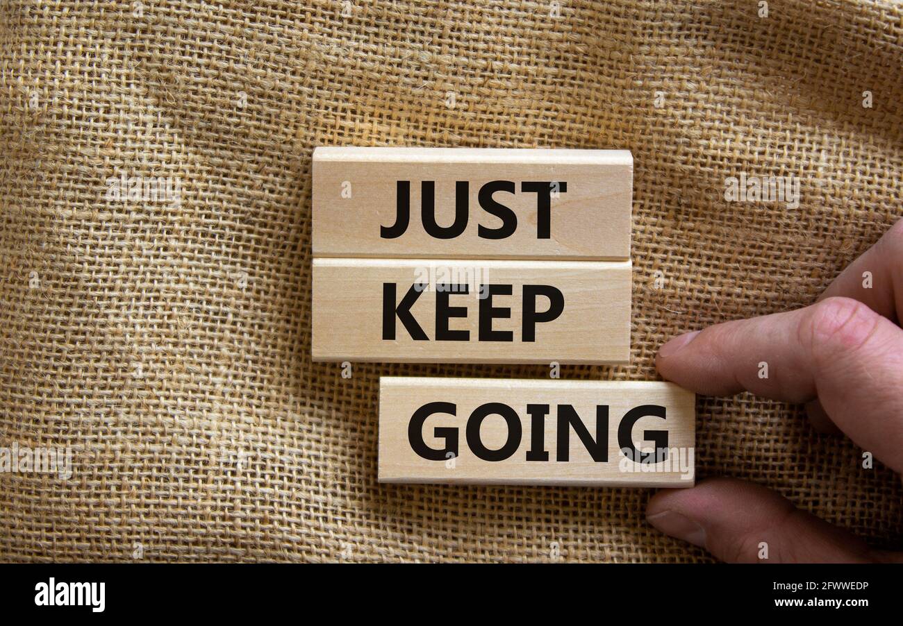 Just keep going symbol. Wooden blocks with words 'Just keep going ...