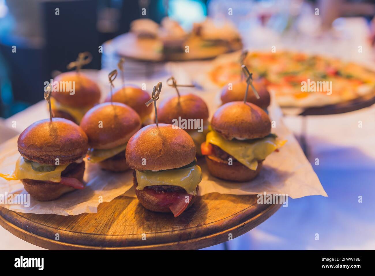 Small burgers served on one plate as appetizers Stock Photo - Alamy