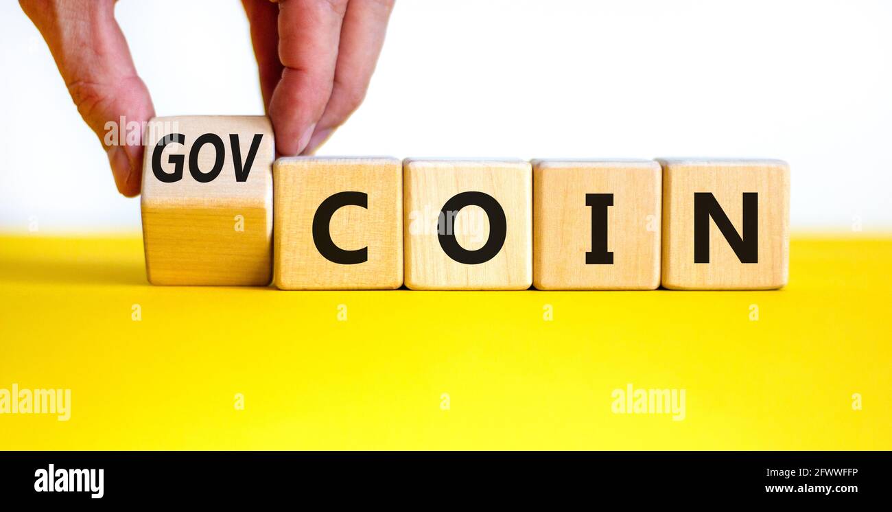 Govcoin symbol. Businessman turns wooden cubes and changes the word ...