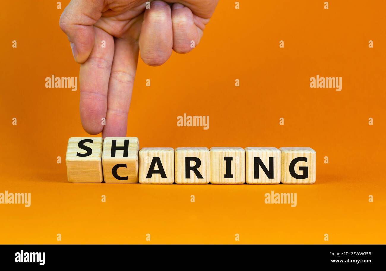 Sharing is caring symbol. Businessman turns wooden cubes and changes ...