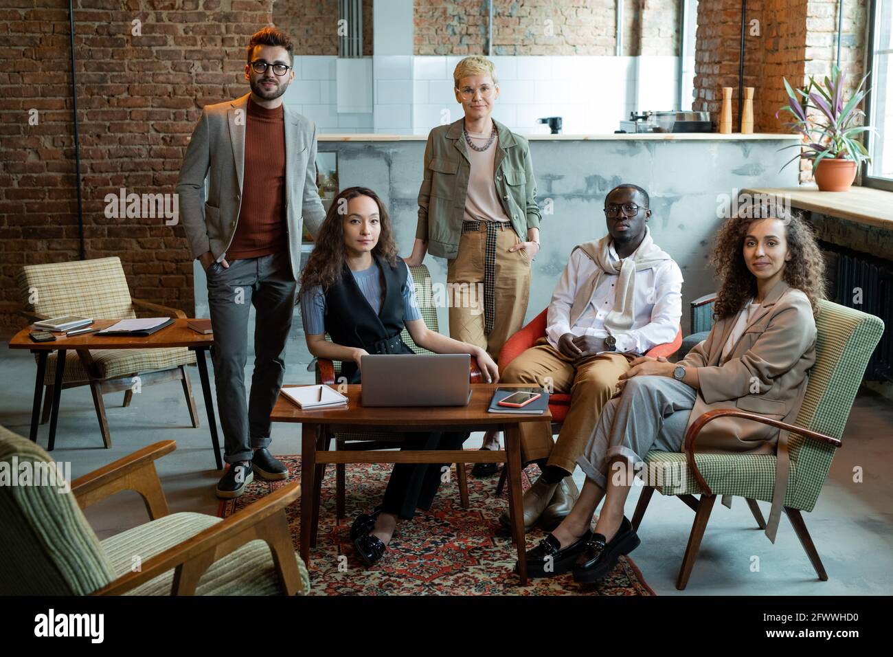 Group of office managers in smart casualwear working together Stock ...