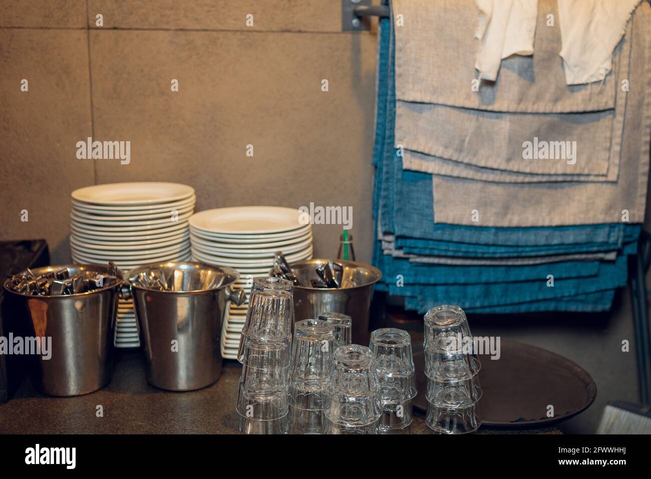 Restaurant waiter serves a table, close-up. The waiter serves empty ...