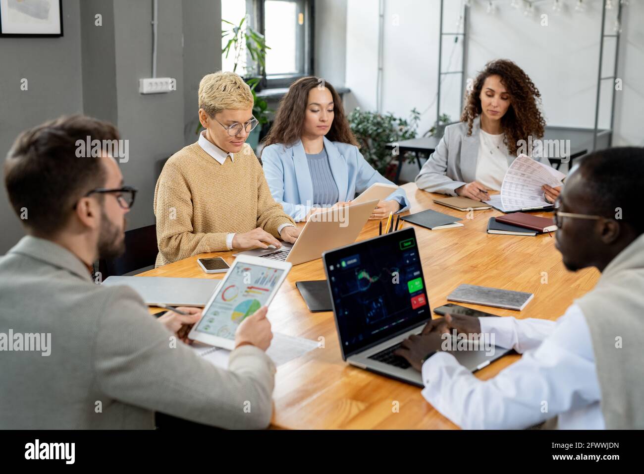 Large group of financier working individually by table in office Stock ...