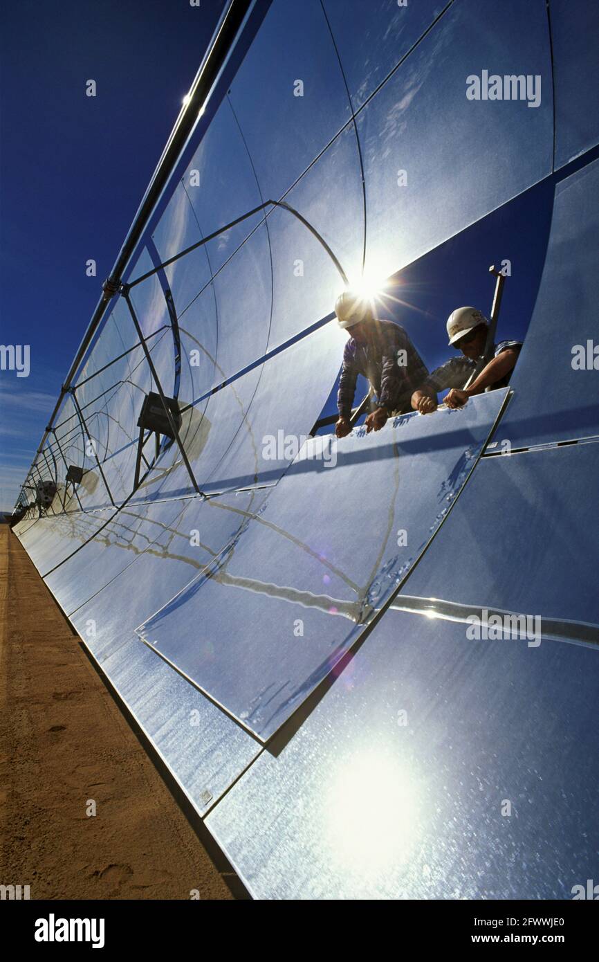Technicians with solar electric generator mirrors at a plant in Kramer ...
