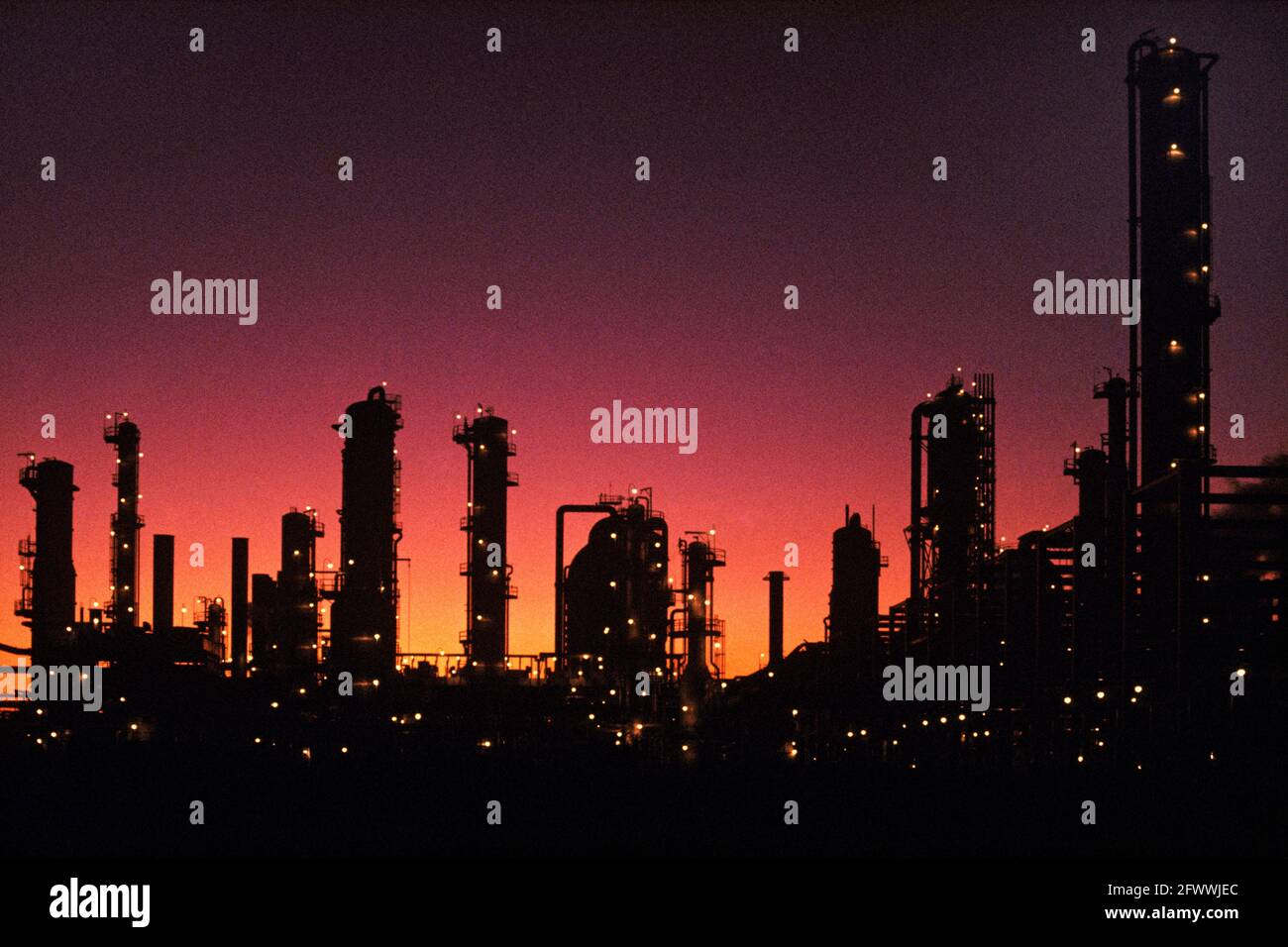 The fracking towers of a petrochemical refinery at dusk in Long Beach ...