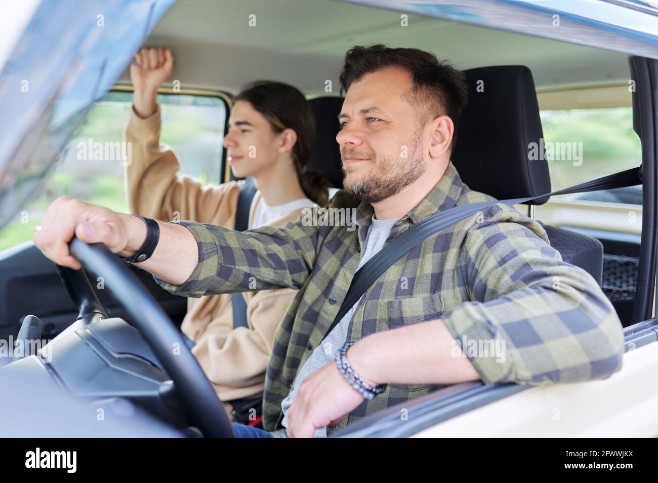 Father And Teenage Son Driving