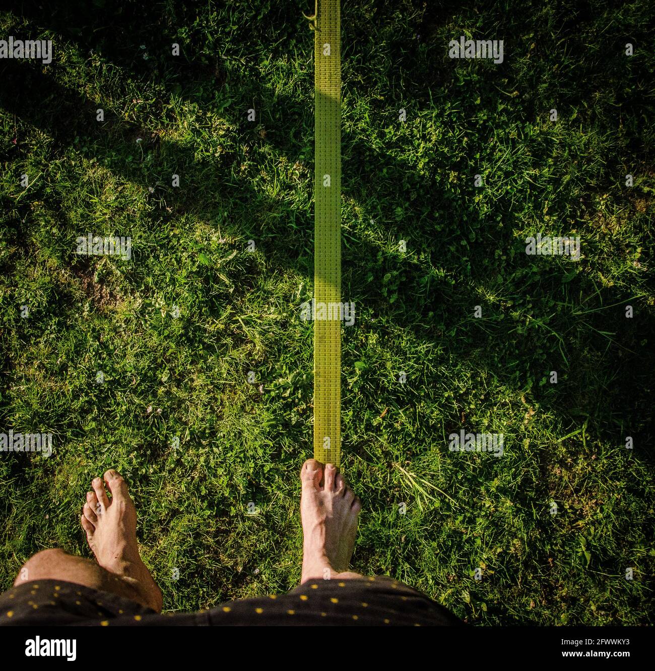 Feet of an athlete walking on a thin line on top of the grass Stock ...