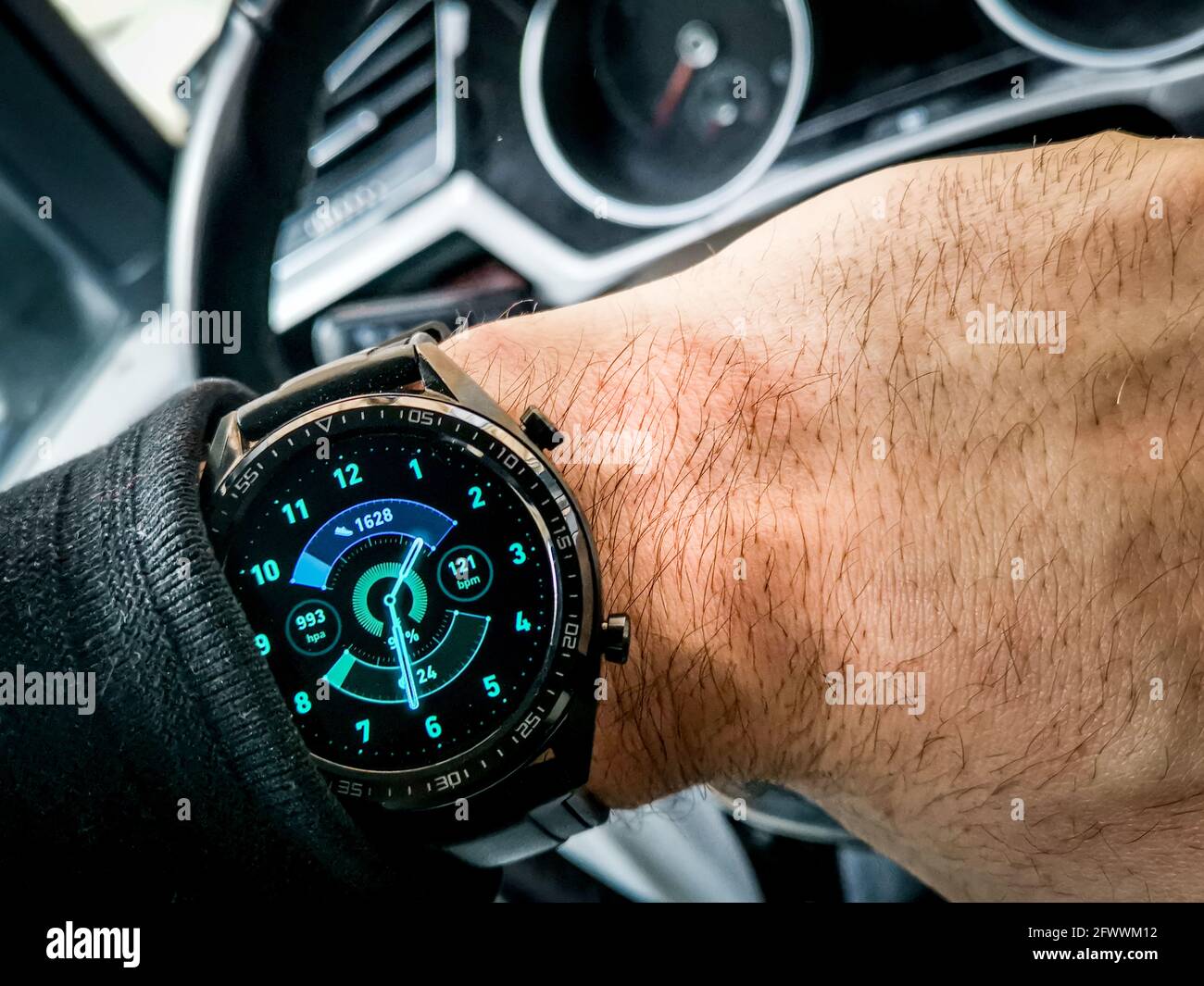 Modern black watch on a wrist of a man sitting in a car Stock Photo - Alamy