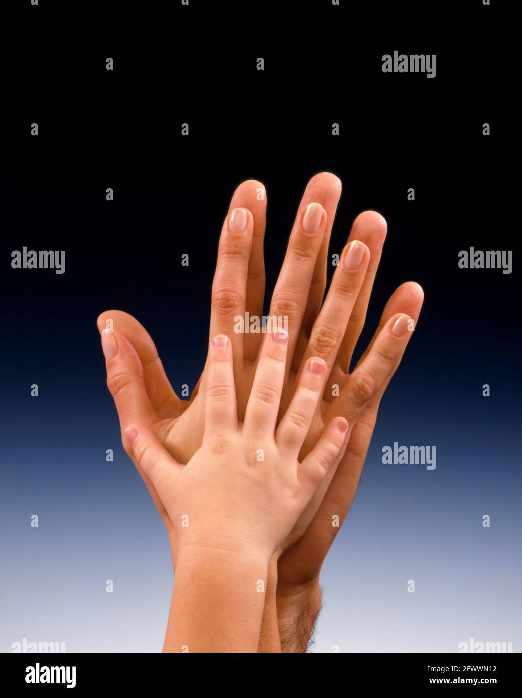 Three Upraised Hands of Family Stock Photo - Alamy
