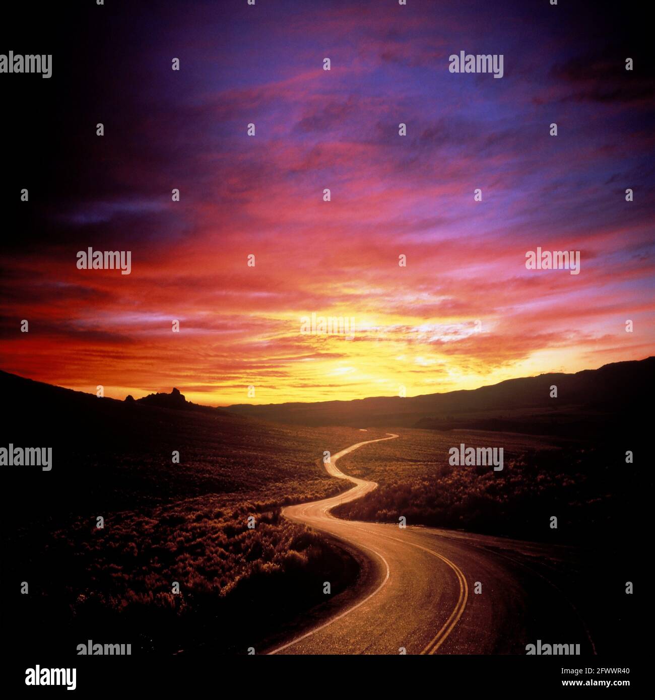 Road Winding Into Sunrise Stock Photo - Alamy