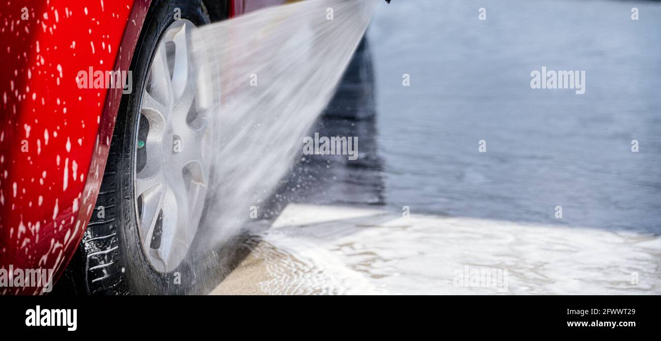 Cleaning the rim and tire. Manual car wash Stock Photo - Alamy