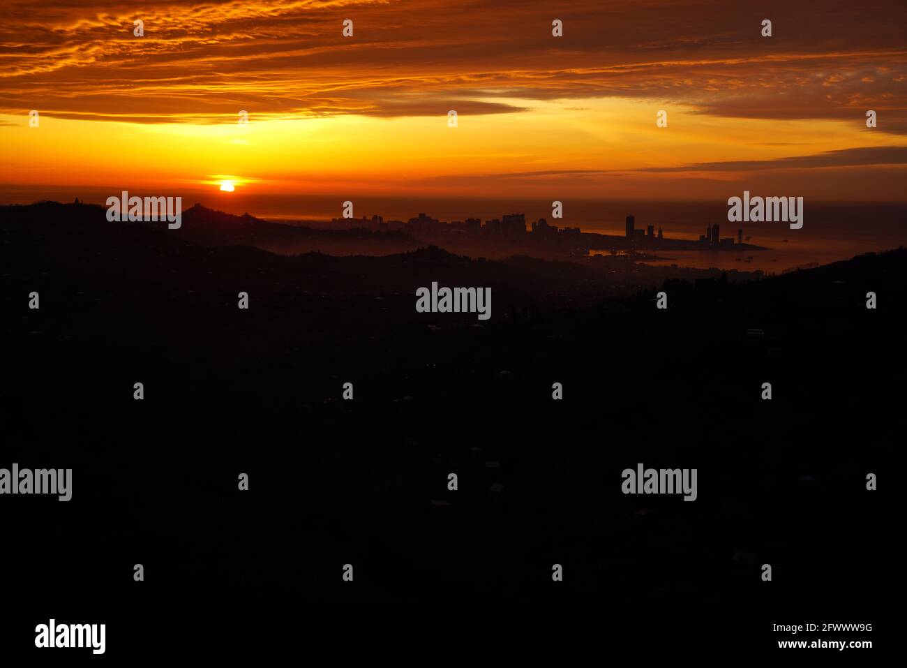 Beautiful yellow sunset on the background of the city Stock Photo - Alamy