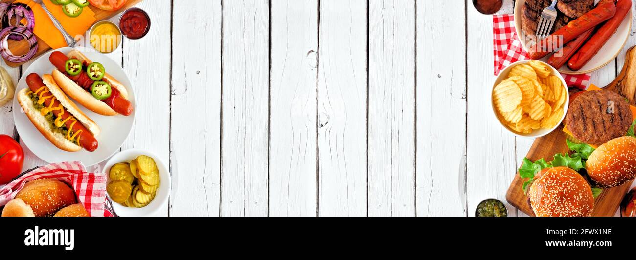 Summer BBQ food table scene with hot dog and hamburger buffet. Top view ...