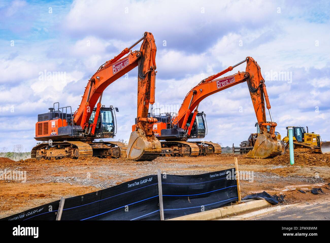 Two Orange Loaders at Construction Site Stock Photo - Alamy