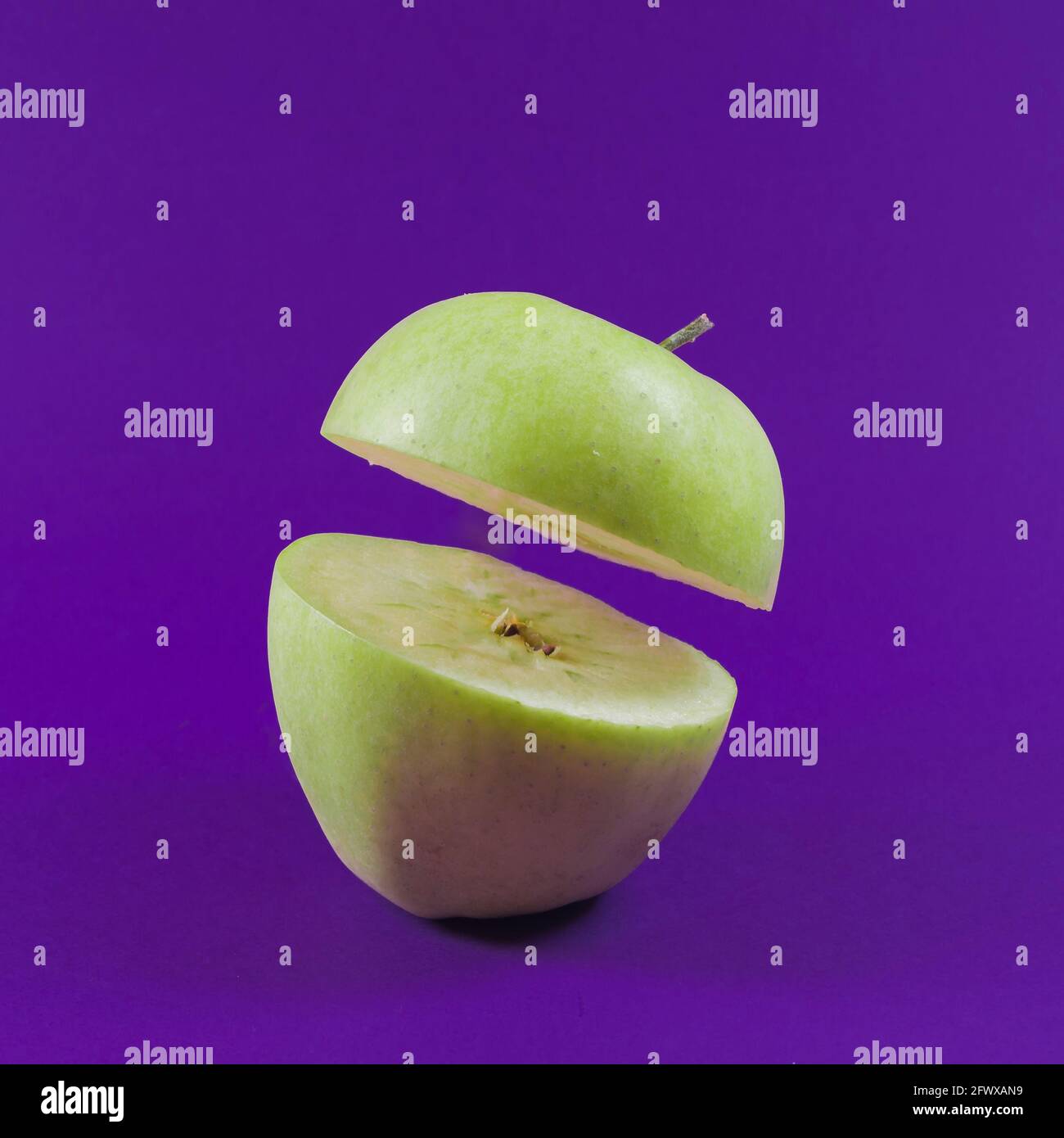 Sliced green apple floating on trendy lavender background. Ultra violet ...