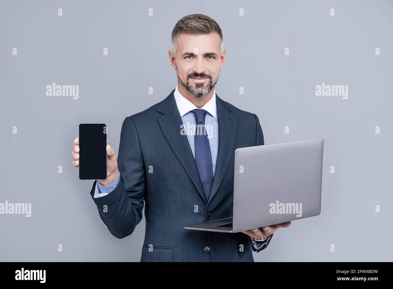 mature businessman work online. business success. man use pc and smartphone. entrepreneur Stock ...