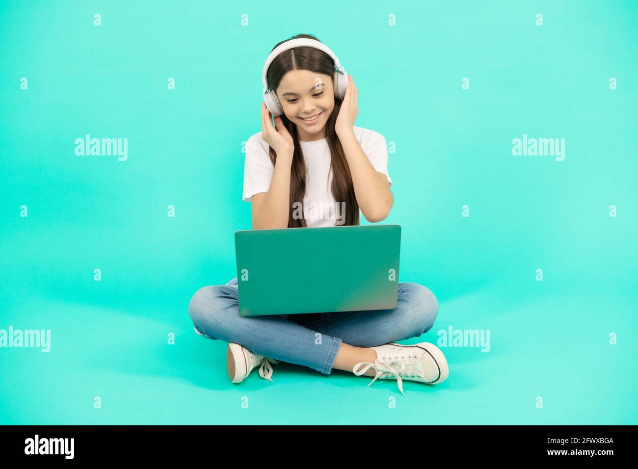 happy teen girl use computer for video call or listen webinar in ...