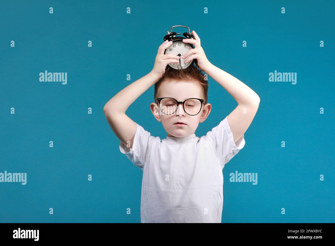 Time management. Morning. little boy with alarm clock. Happy childhood ...