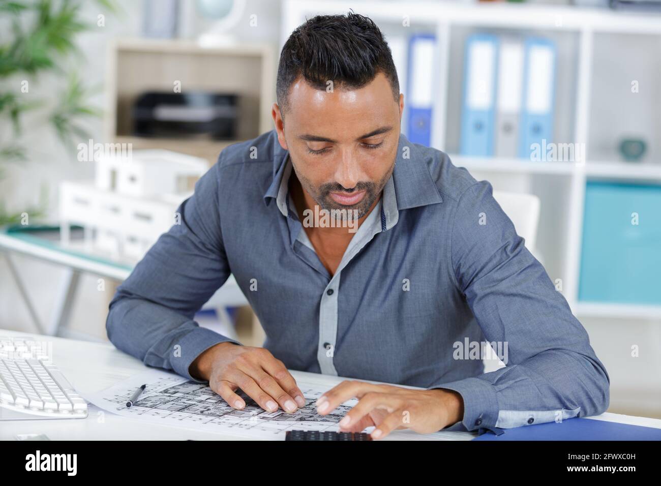 architect using calculator in the office Stock Photo - Alamy