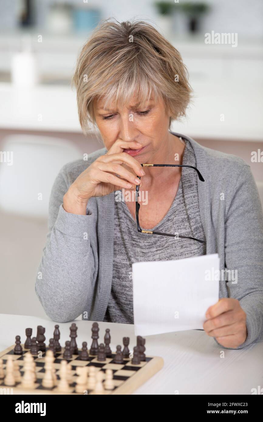photo of woman senior playing chess Stock Photo - Alamy