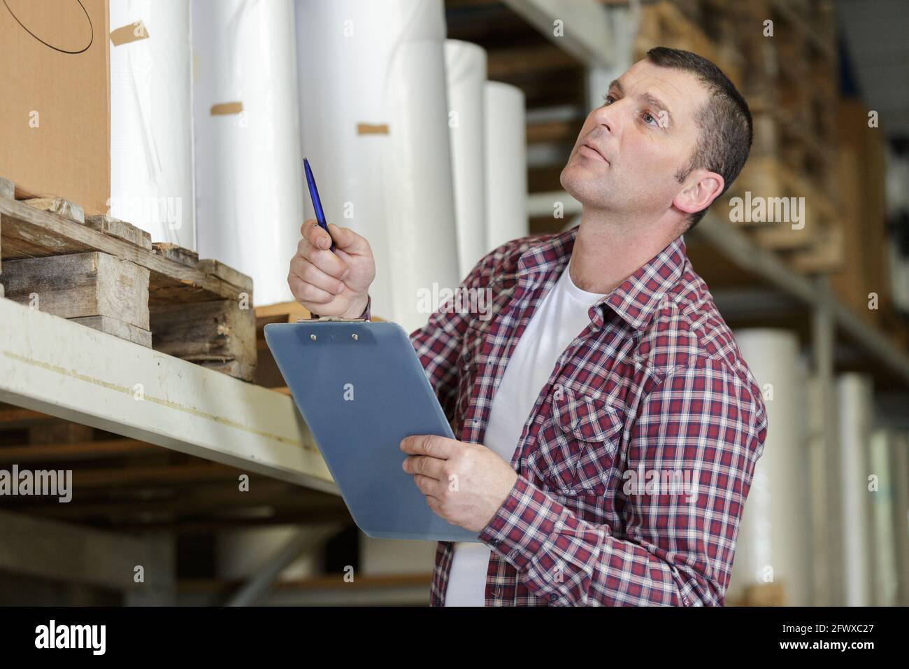 factory man worker checking paperwork Stock Photo - Alamy
