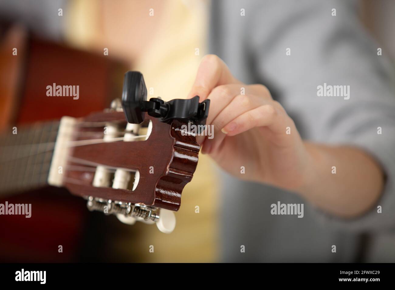 Guitar and female fingers tuning hi-res stock photography and images ...