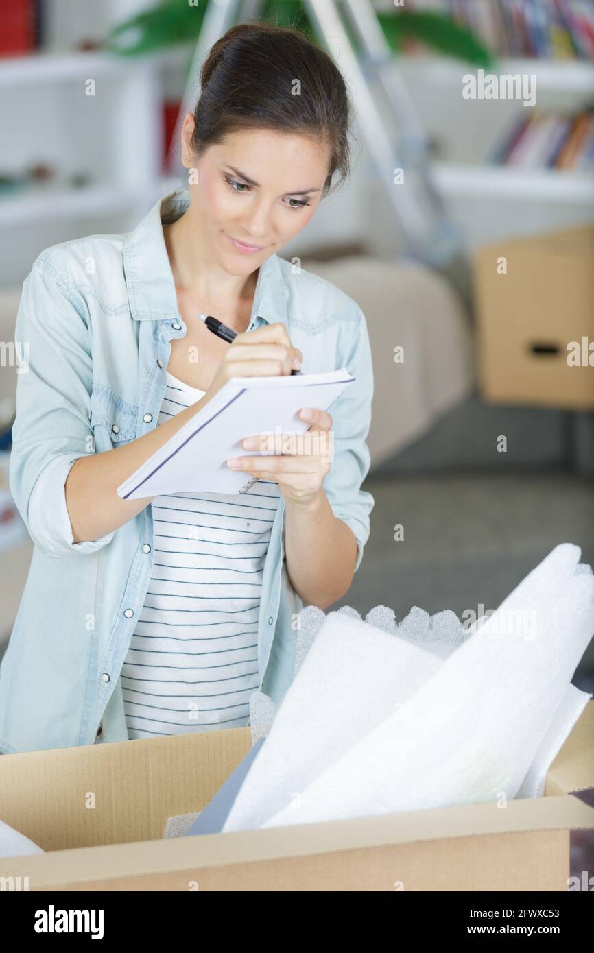 a woman unpacking the box Stock Photo - Alamy