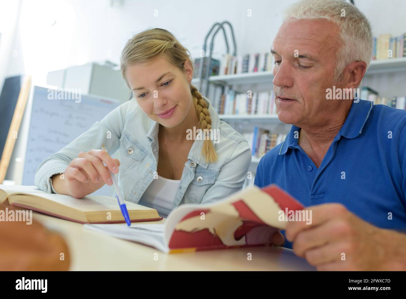 teacher giving private lessons to woman Stock Photo - Alamy