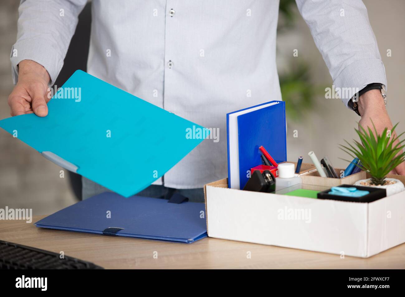 a person packing office things Stock Photo - Alamy