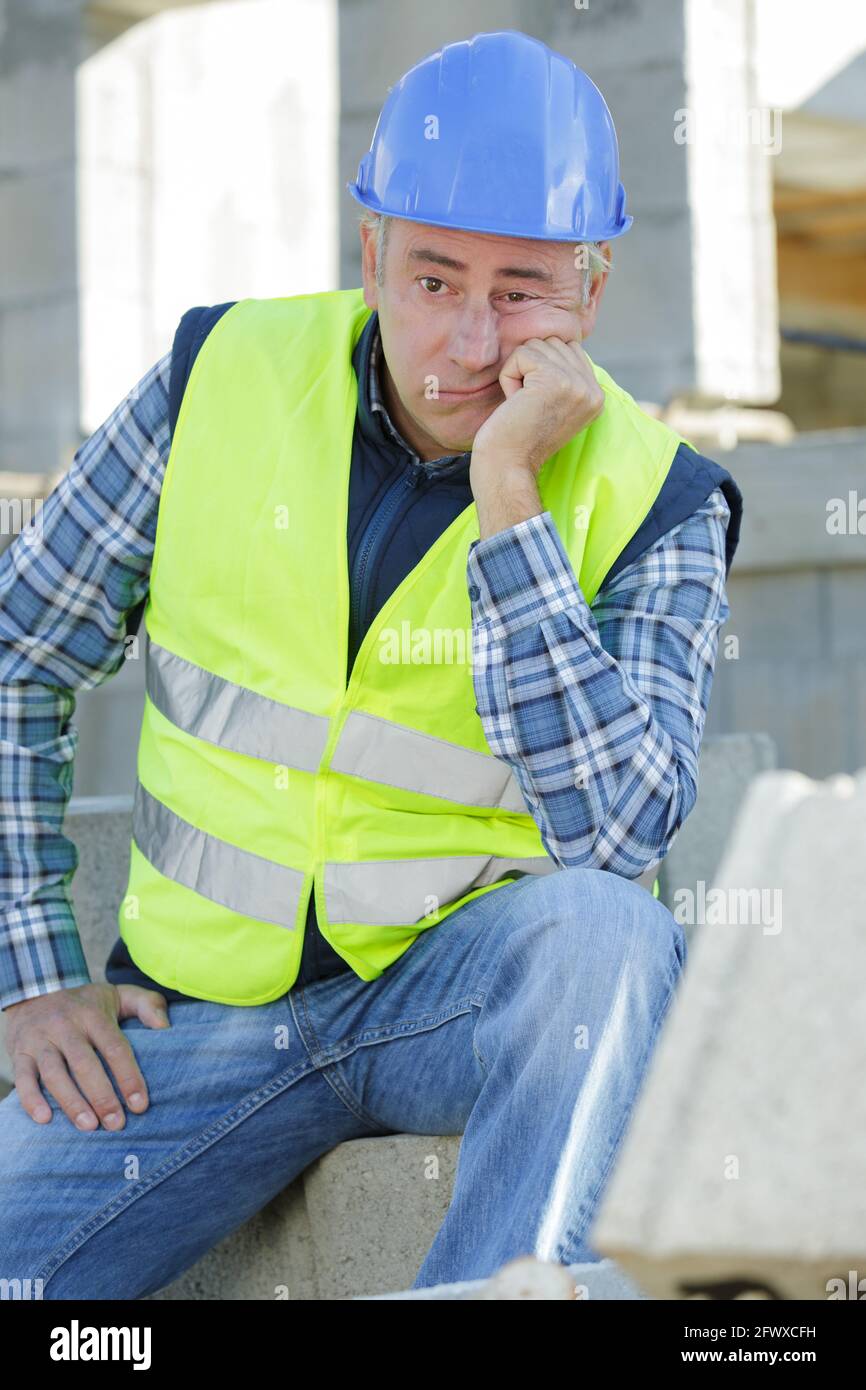 miserable older construction worker on site Stock Photo - Alamy