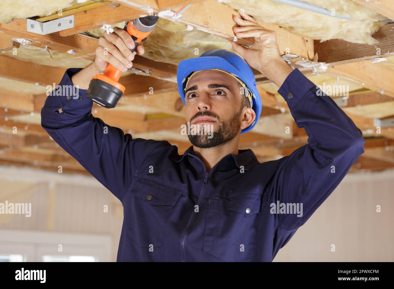 a carpenter drilling the wood Stock Photo - Alamy