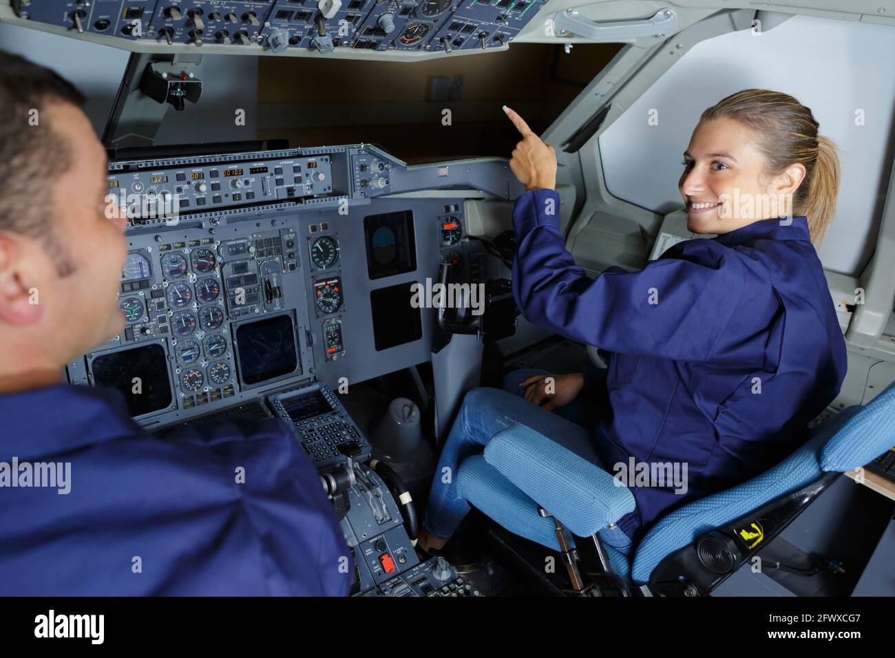 woman pilot pointing at cockpit during flight Stock Photo - Alamy