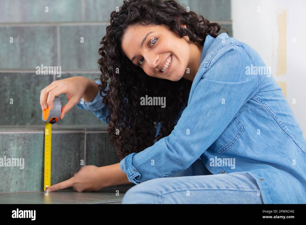 young woman measuring tiled step Stock Photo - Alamy