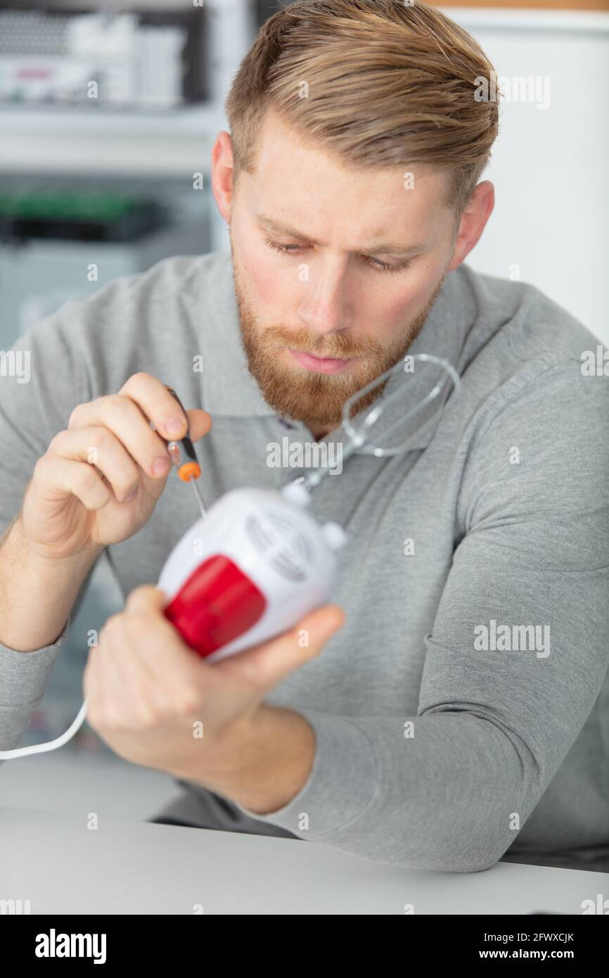 Young handsome man repairing hi-res stock photography and images - Alamy