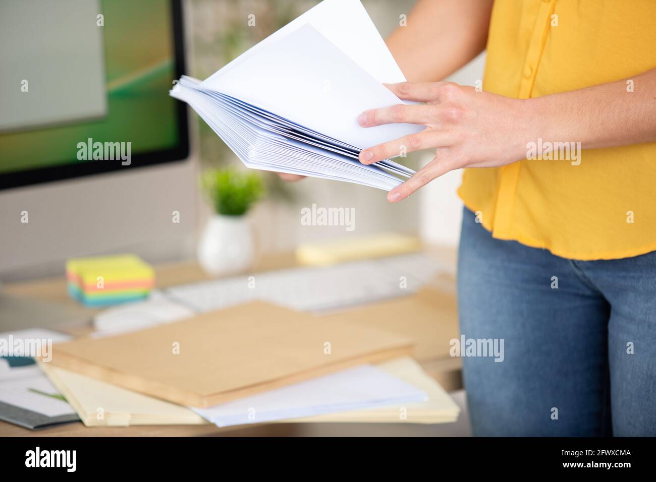 Girl holding stack paper hi-res stock photography and images - Alamy