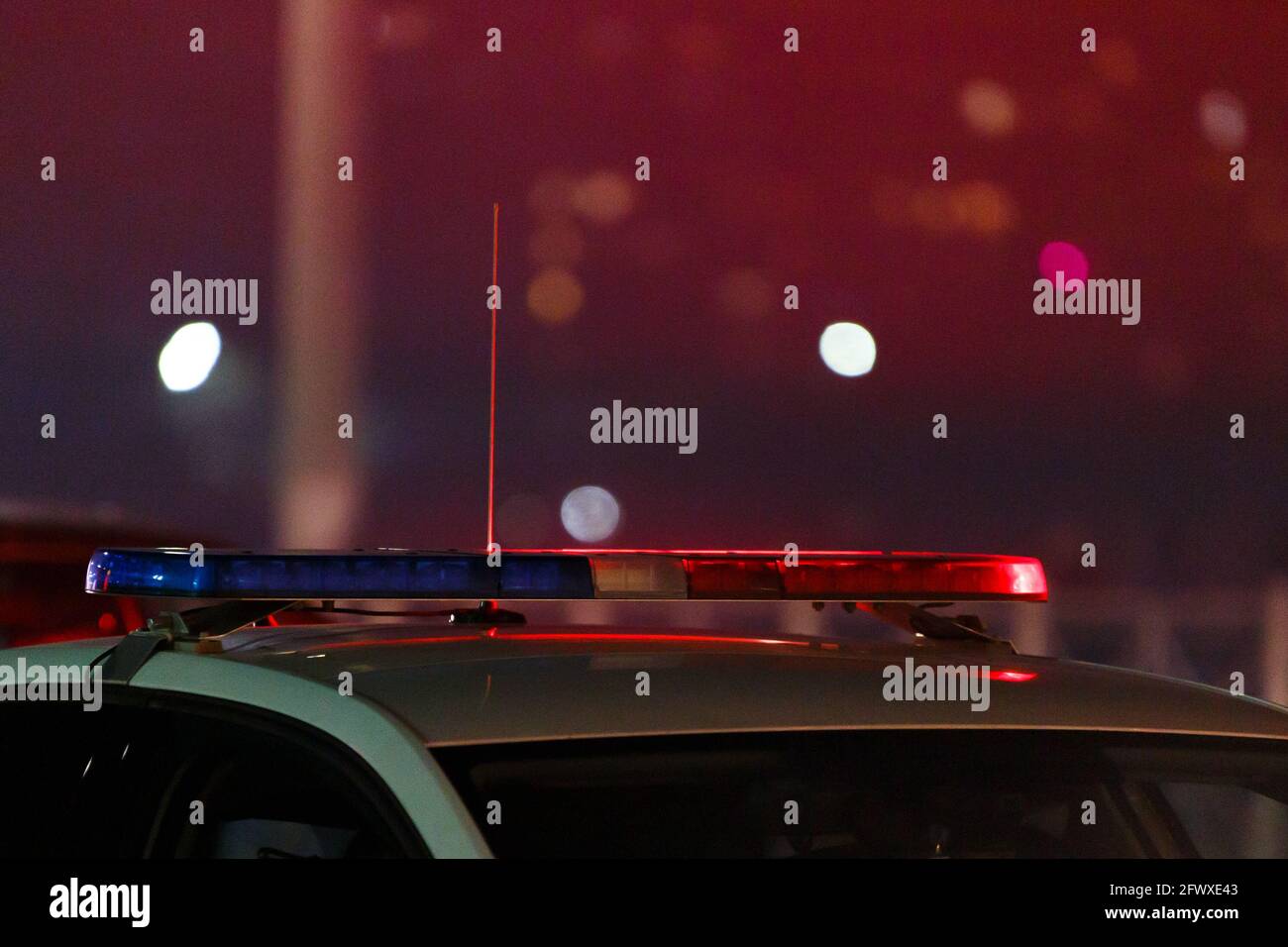 red police car light at night in city with selective focus and bokeh on ...