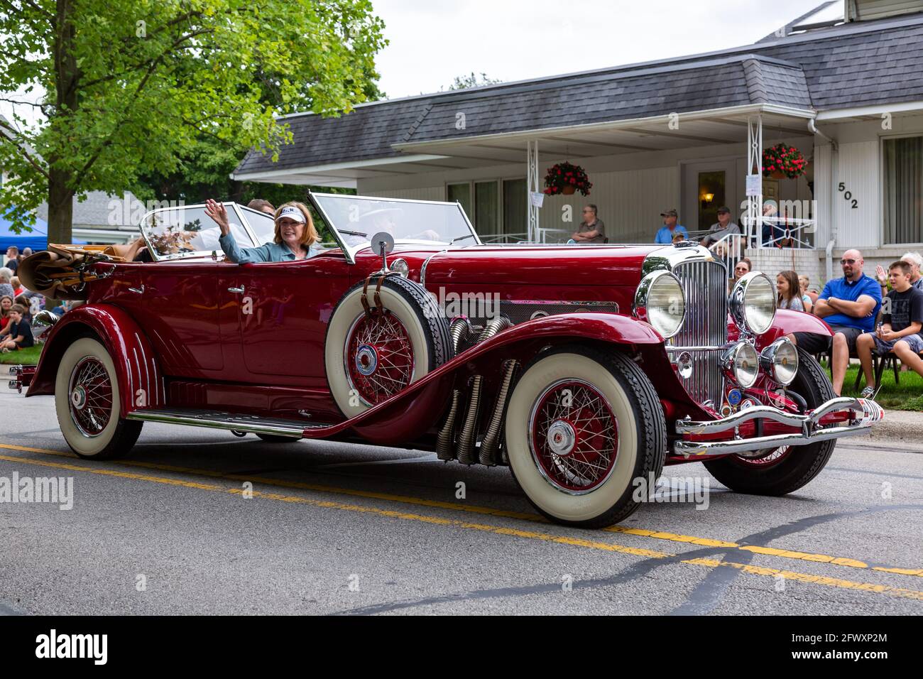 A red antique Duesenberg classic automobile cruises through Auburn ...