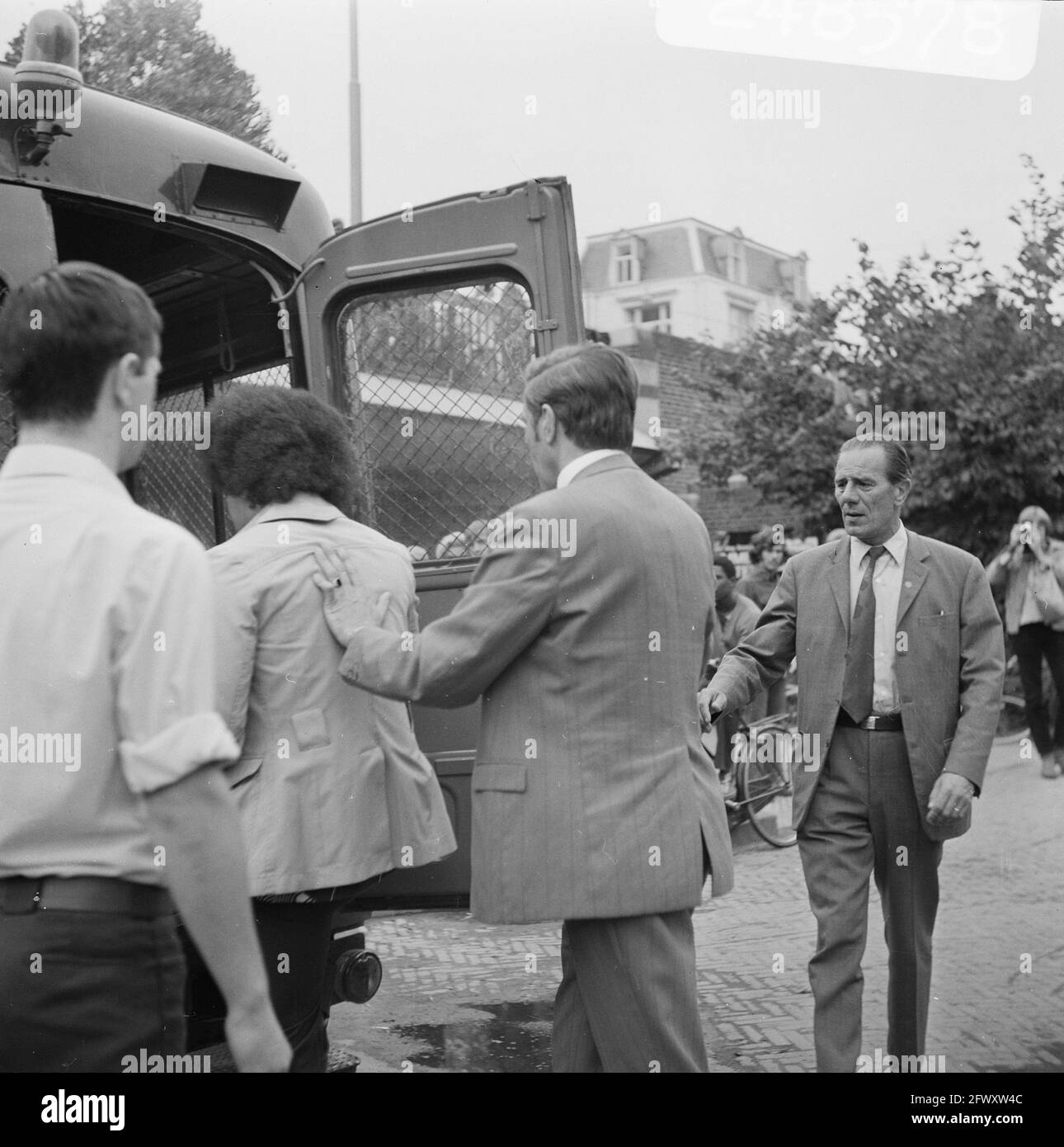 Police detectives (in white suits) make arrests in Studio 7 in ...