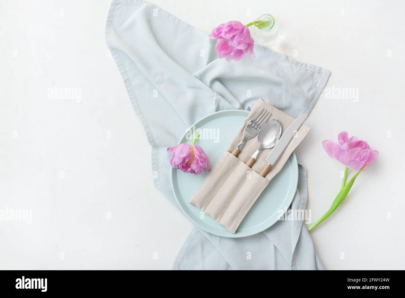 Beautiful table setting with flowers on white background Stock Photo ...