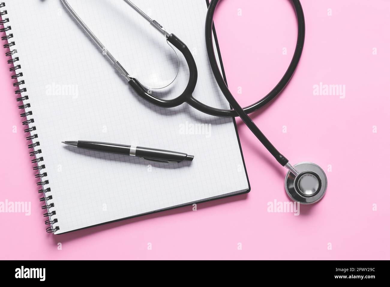 Modern stethoscope, notebook and pen on color background Stock Photo ...