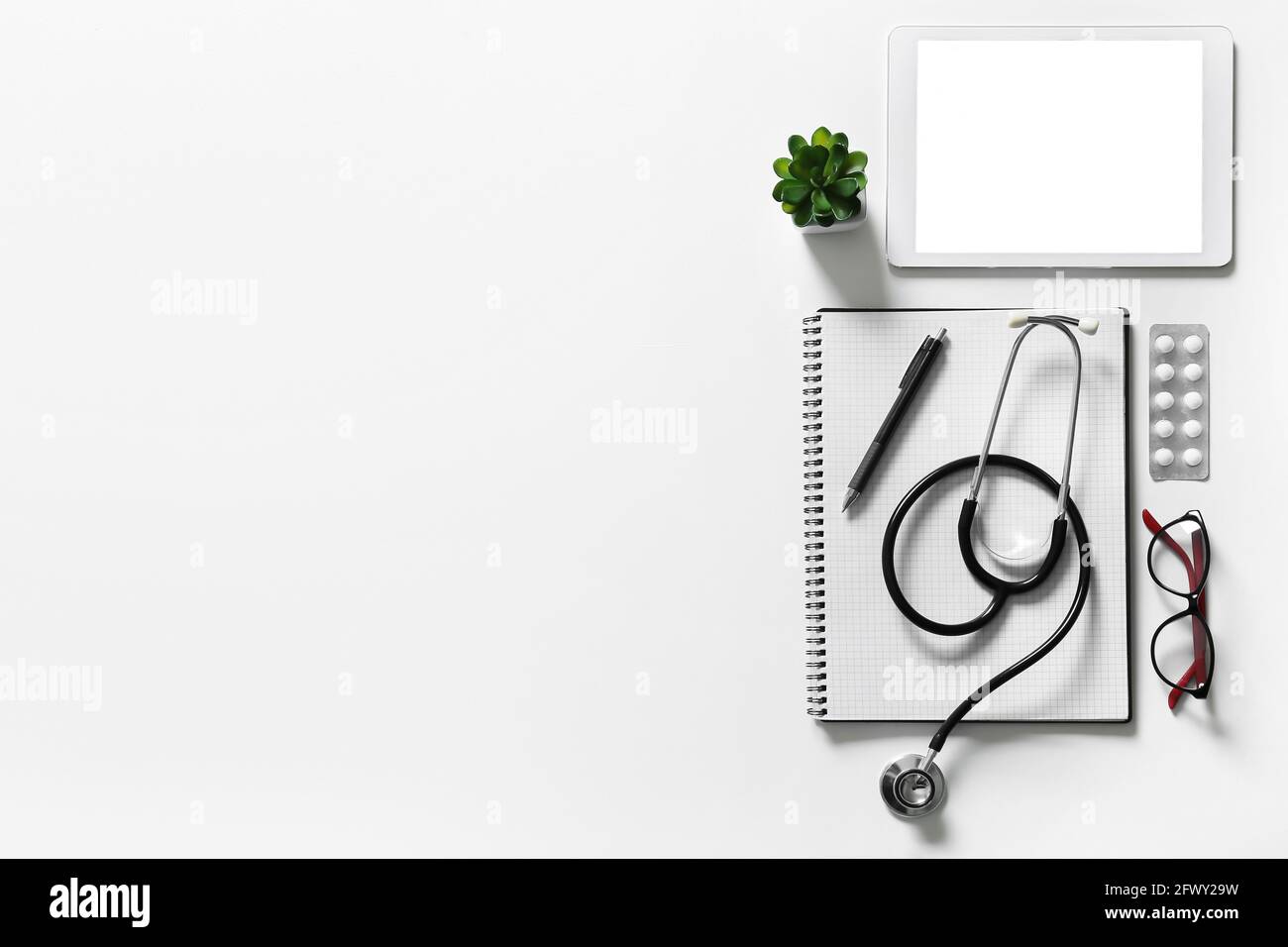 Composition with modern stethoscope and tablet computer on light ...