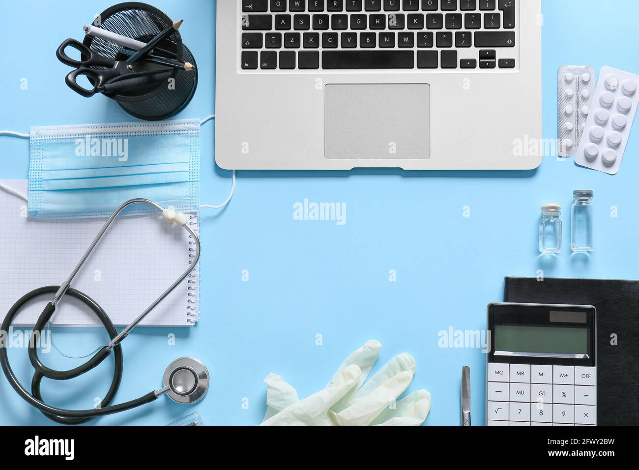 Composition with modern stethoscope and laptop on color background ...