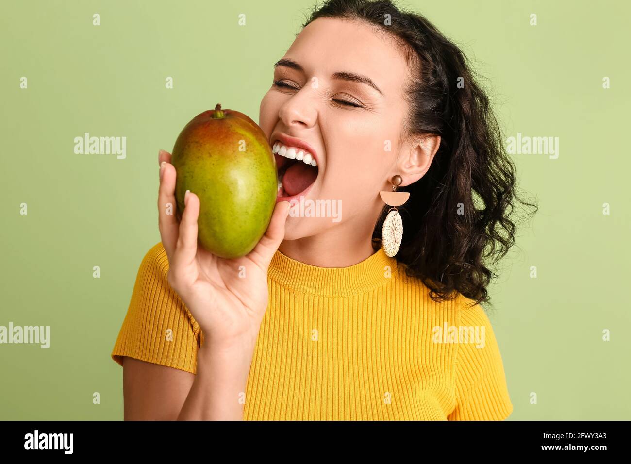 Young woman eating mango model hi-res stock photography and images - Alamy