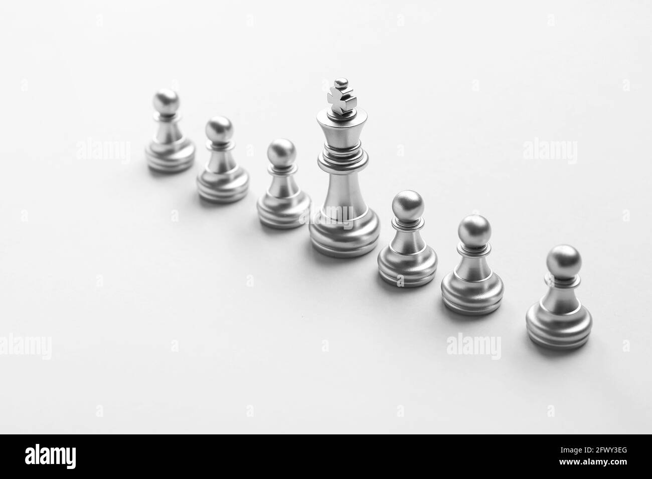 Chess pieces on grey background. Hierarchy concept Stock Photo - Alamy