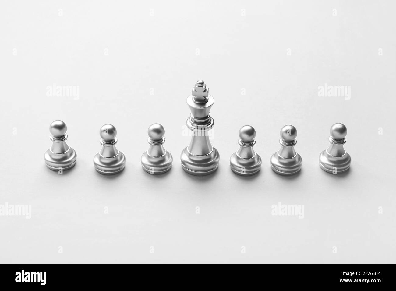 Chess pieces on grey background. Hierarchy concept Stock Photo - Alamy