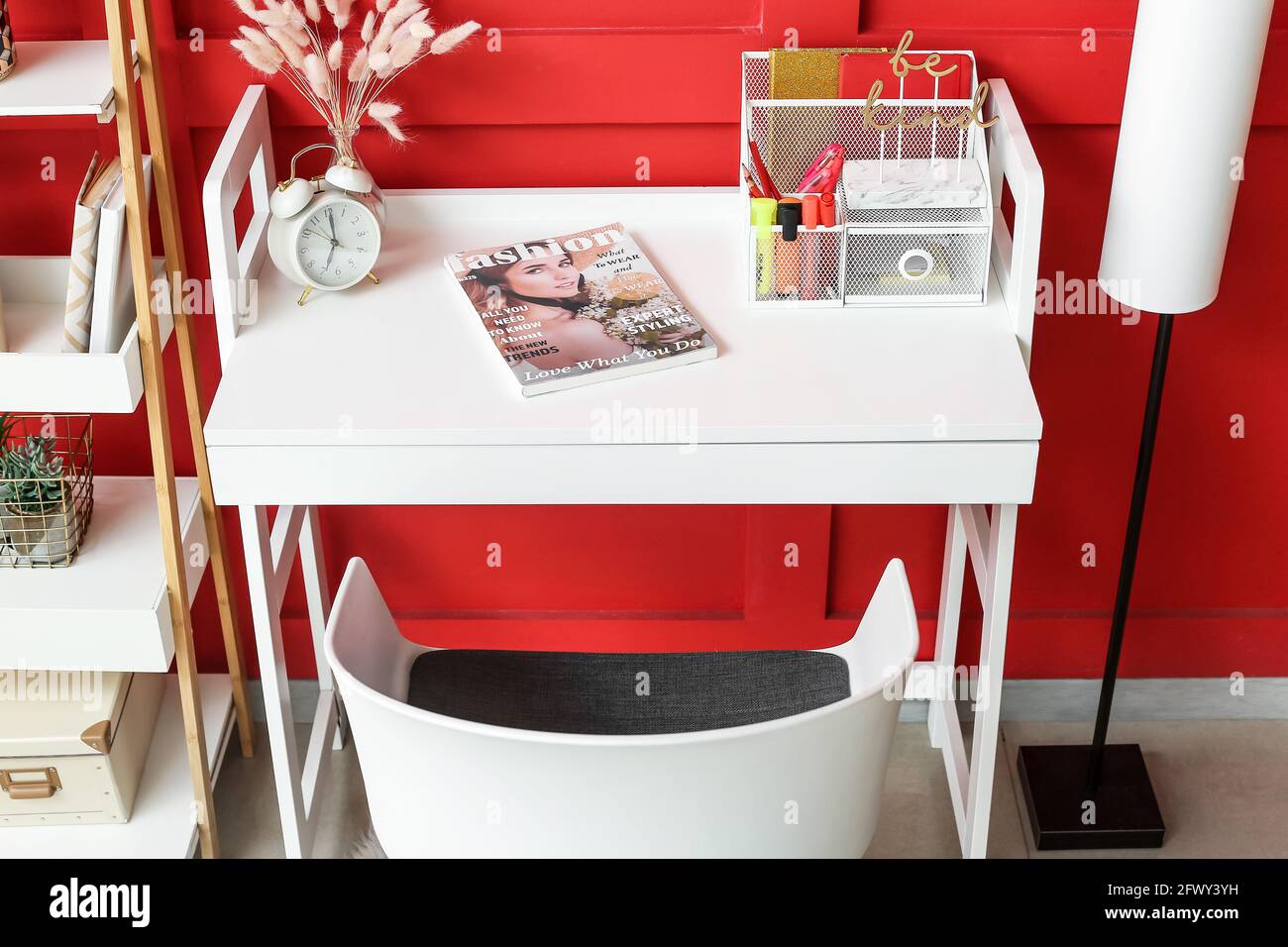 Stylish workplace with organizer near color wall Stock Photo - Alamy