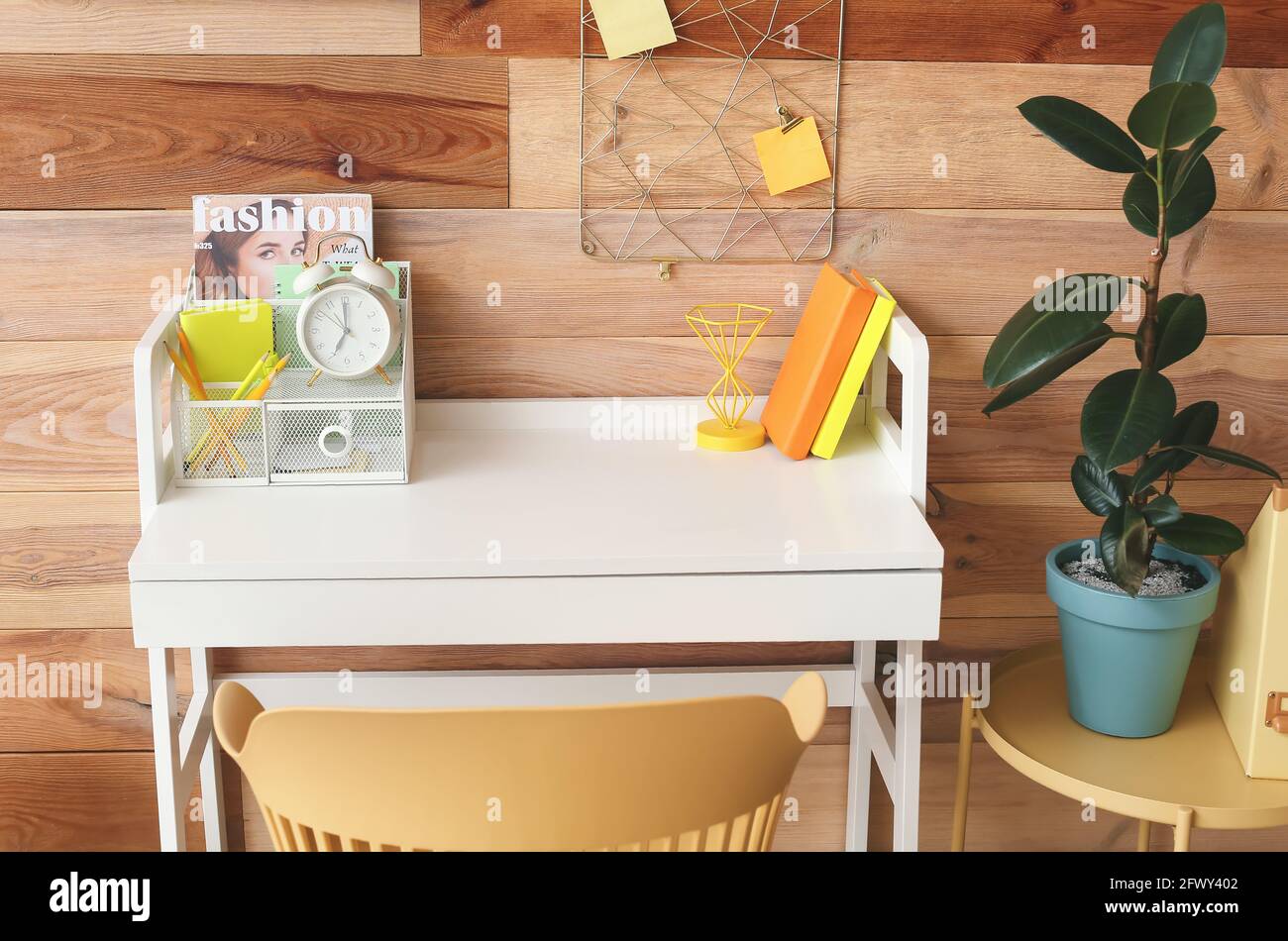 Modern workplace with organizer near wooden wall Stock Photo - Alamy
