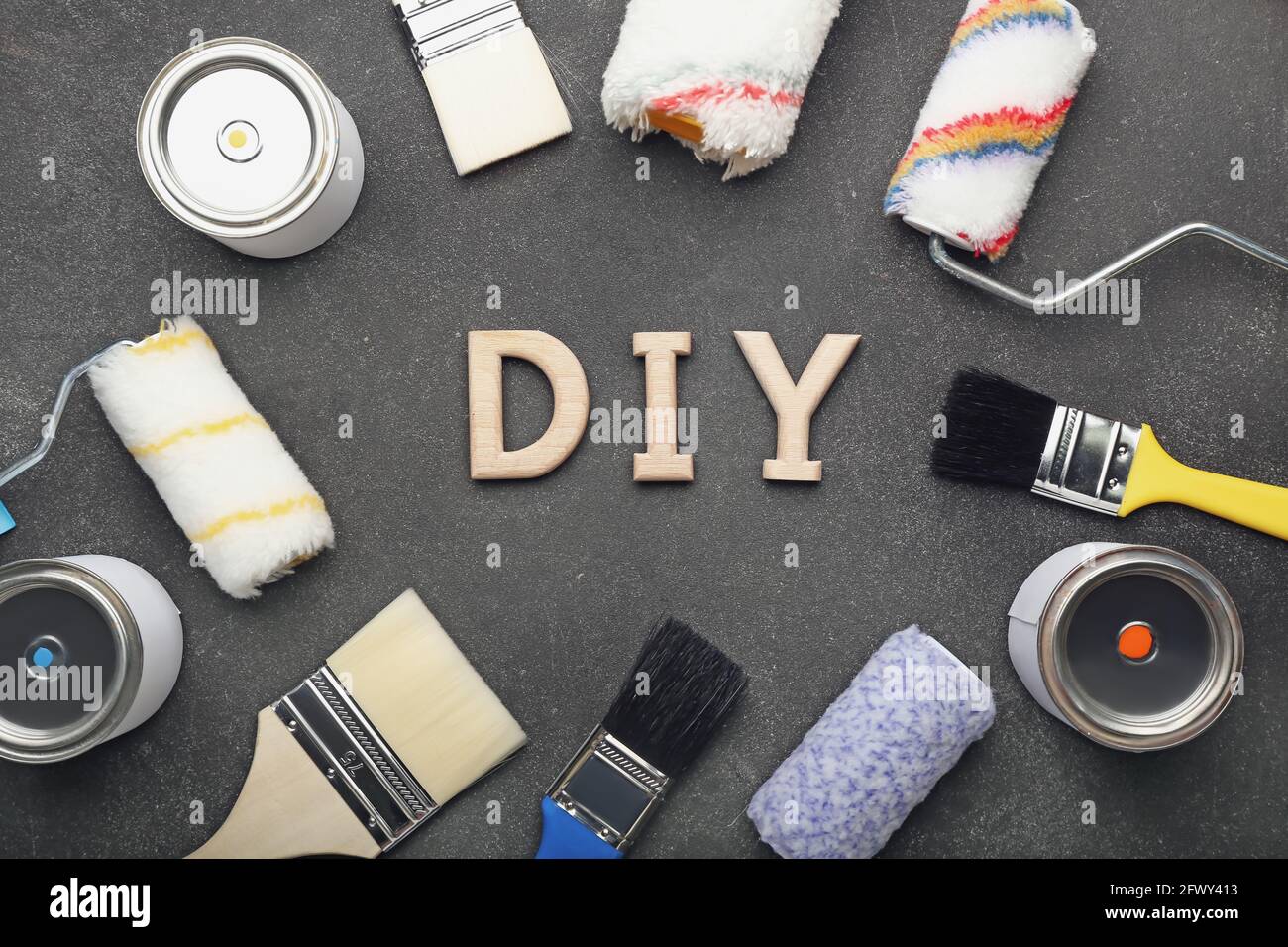 Frame made of painter's tools and word DIY on dark background Stock ...